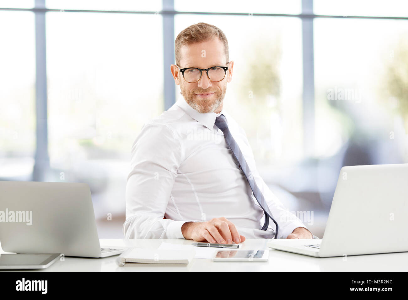 Portrait of middle aged senior agent wearing shirt and tie while ...