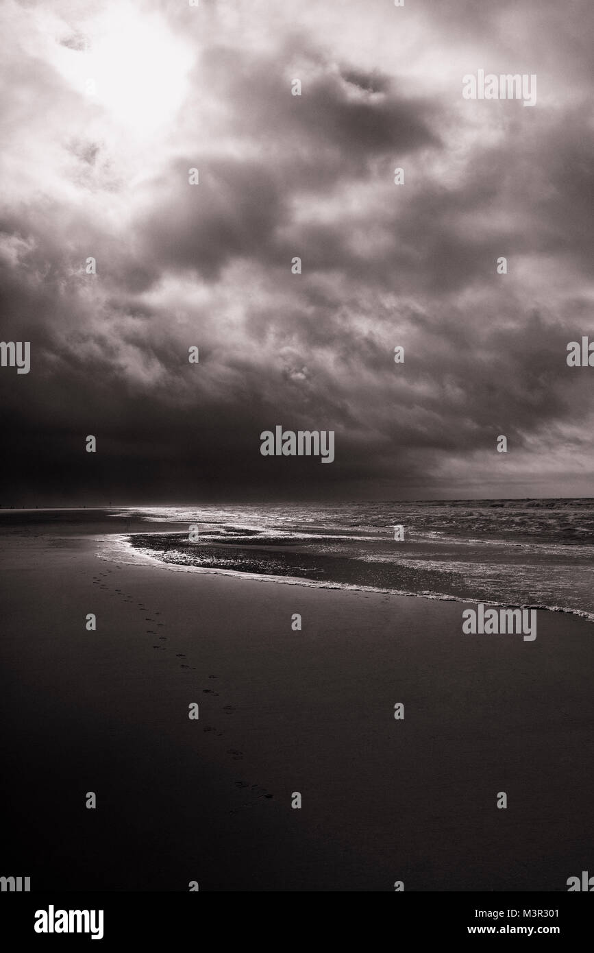 Dramatic stormclouds at Sankt-Peter-Ording. Low tide at the North Sea ...