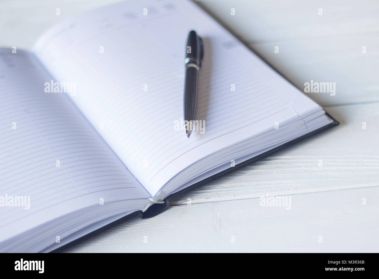 pen and a notebook at the workplace Stock Photo - Alamy
