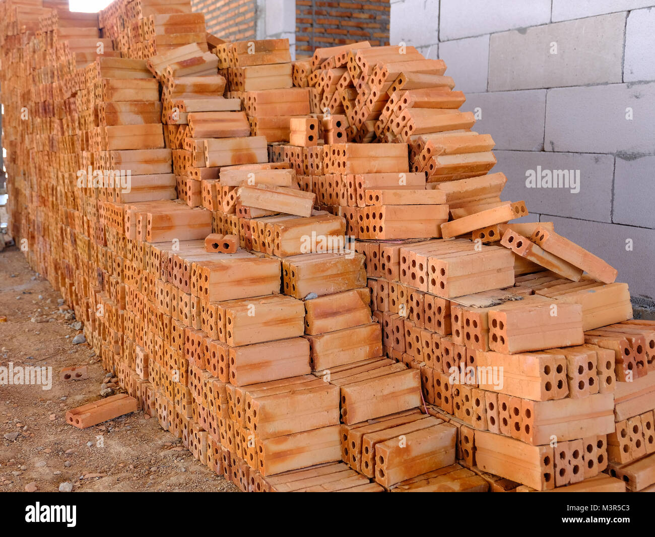 Pile of red bricks which is prepared for construction Stock Photo - Alamy