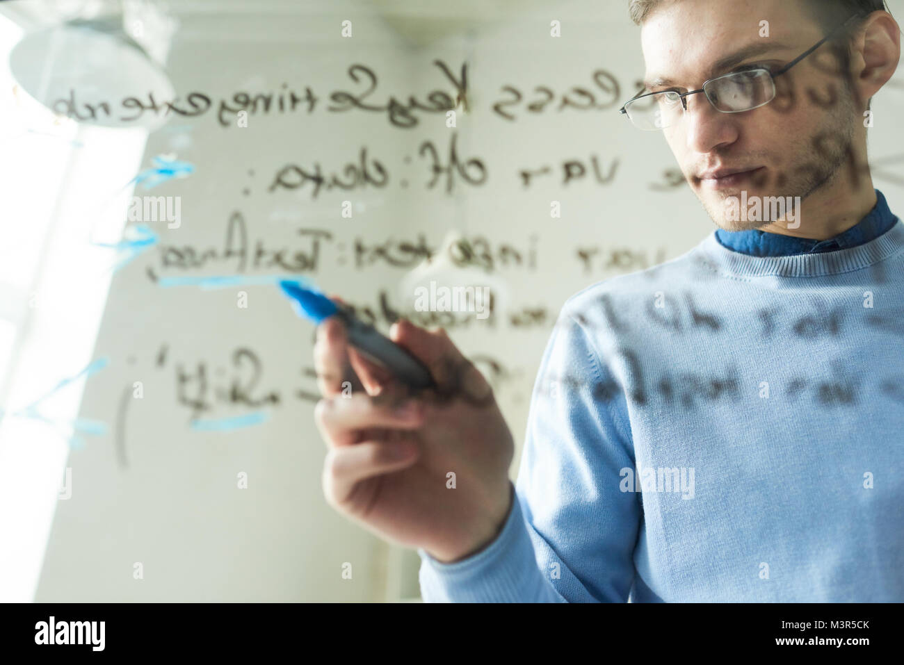 Young man programmer writing code hi-res stock photography and images ...