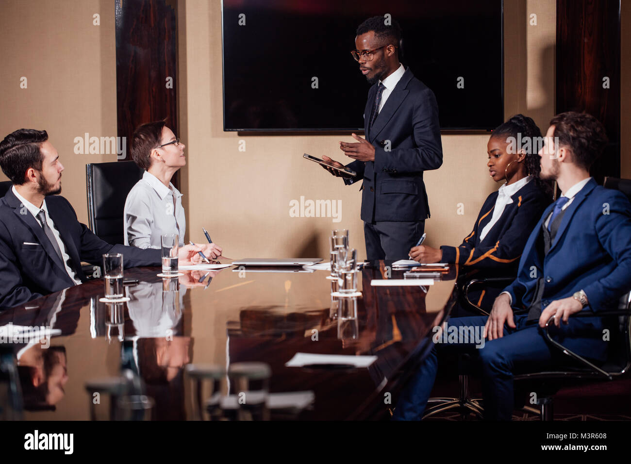 African American business man giving presentation to associates Stock ...