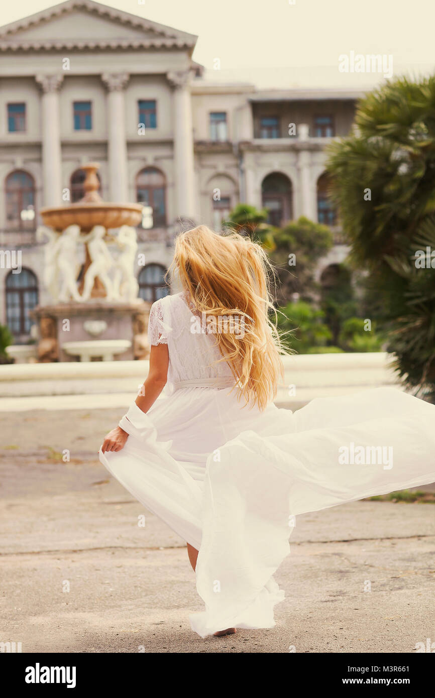 Beautiful happy running bride outdoors in park Stock Photo - Alamy