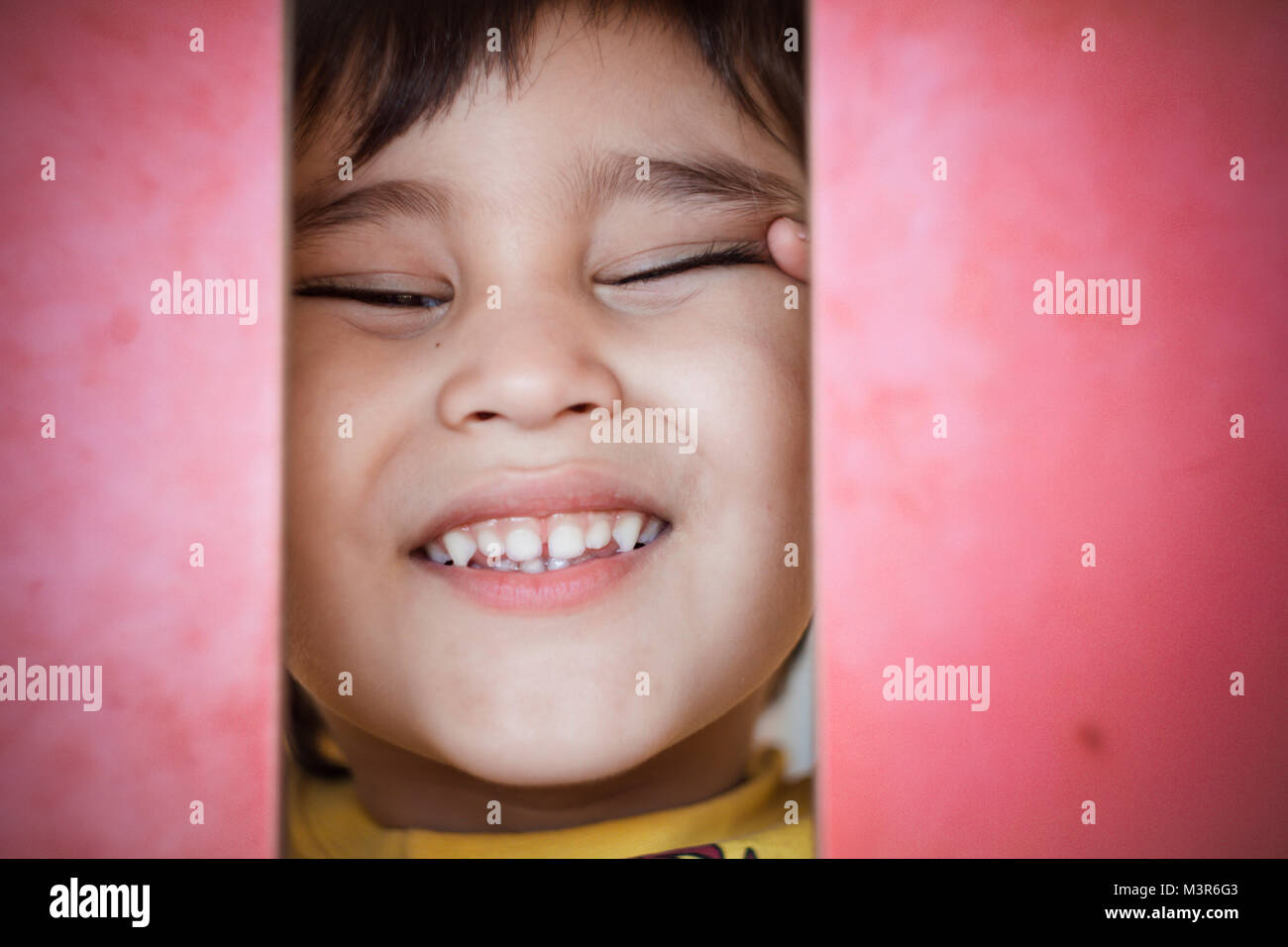 kid joking, Brunette boy putting funny faces in an outdoor park Stock ...