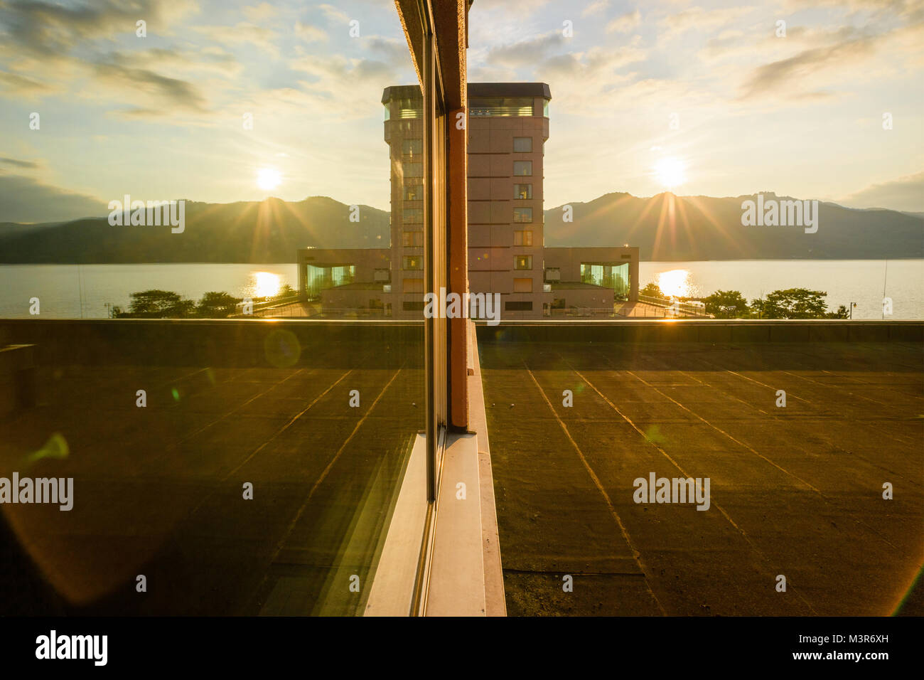 sunset and the reflection on the window Stock Photo - Alamy
