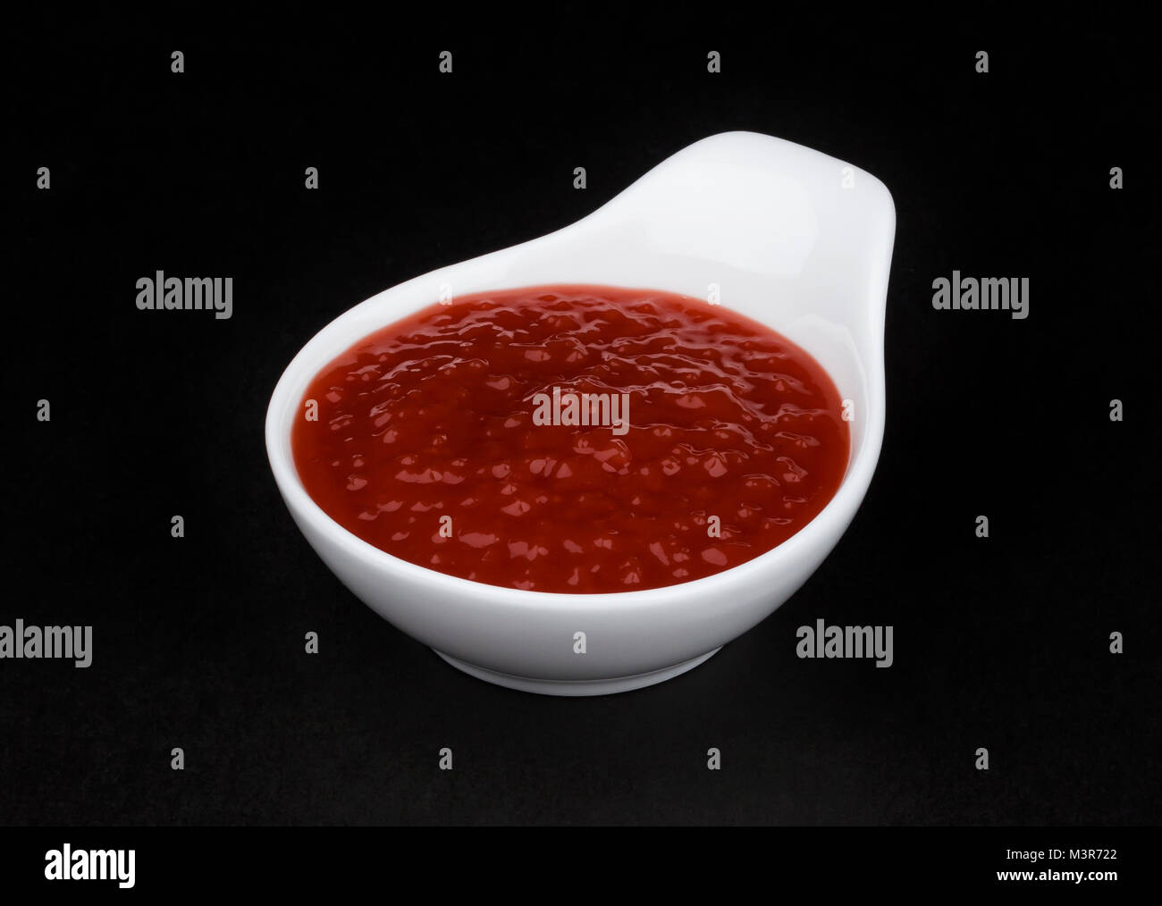 Tomato paste in white bowl isolated on black background with clipping ...