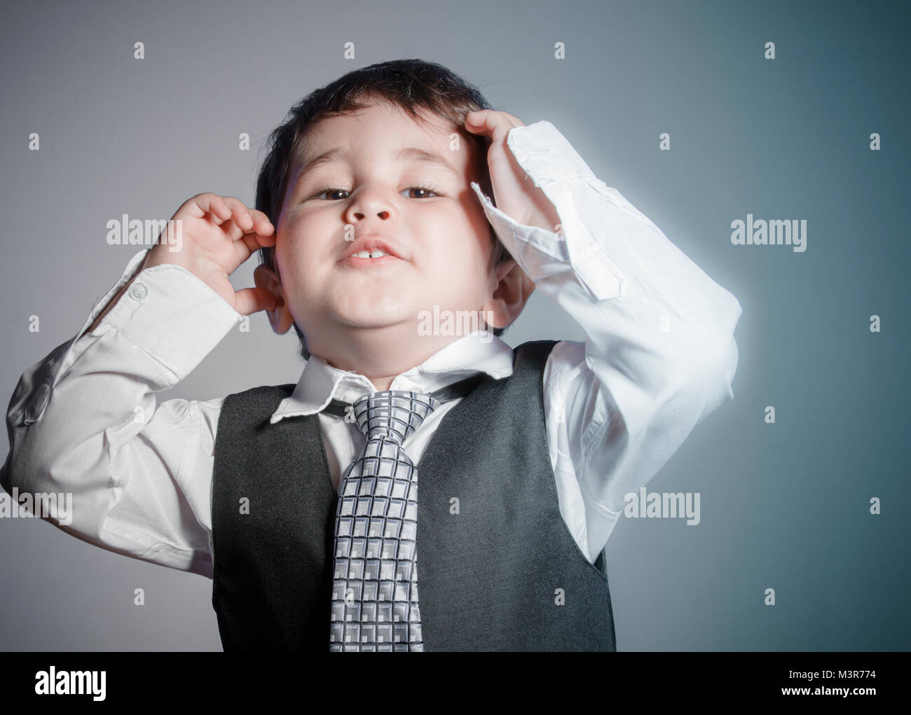 Professional, little businessman, brown-haired boy dressed in suit and ...
