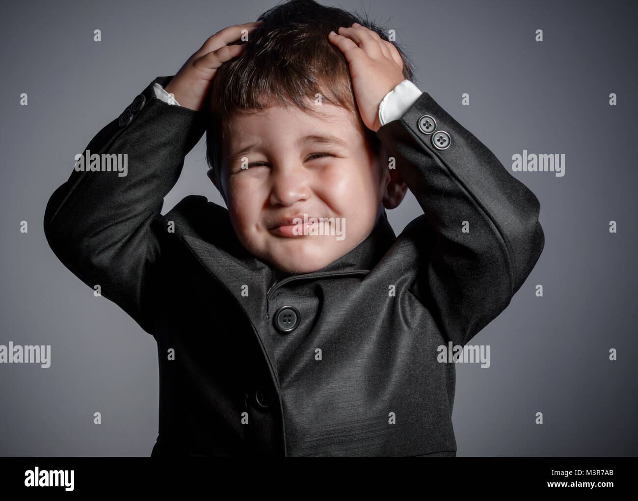 Failure, little businessman, brown-haired boy dressed in suit and tie ...