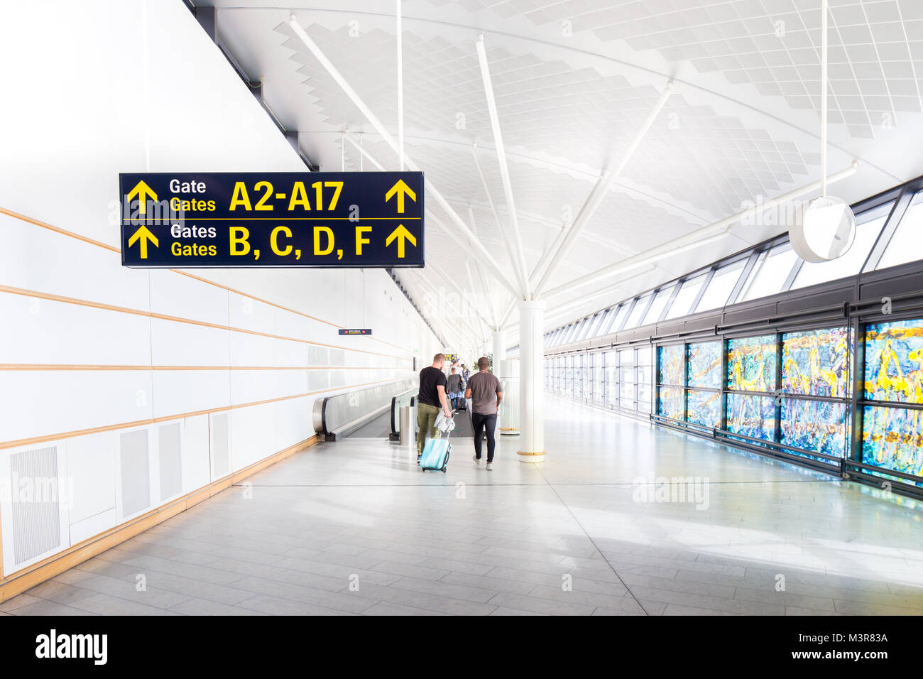 Tourist are walking to different gate by follow the gate label with ...