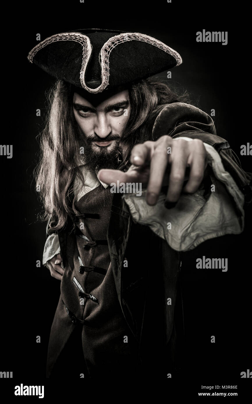 portrait of bearded and hairy pirate pointing into the viewer, shallow ...