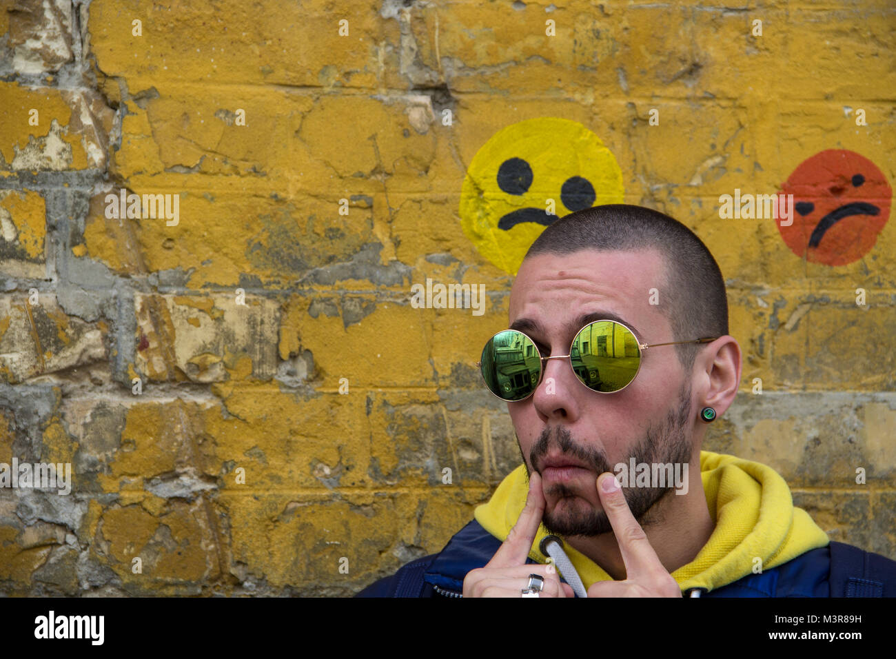 Portrait Of A Young Man In A Blue Jcket With Yellow Hood Stock Photo ...