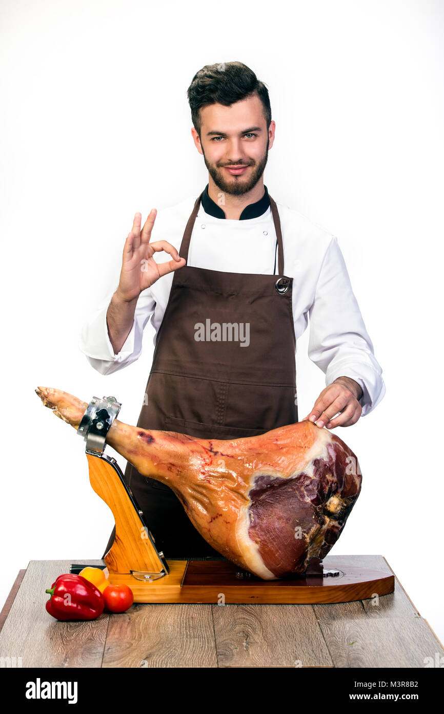 young chef modeling appearance advertises jamon on a white background ...