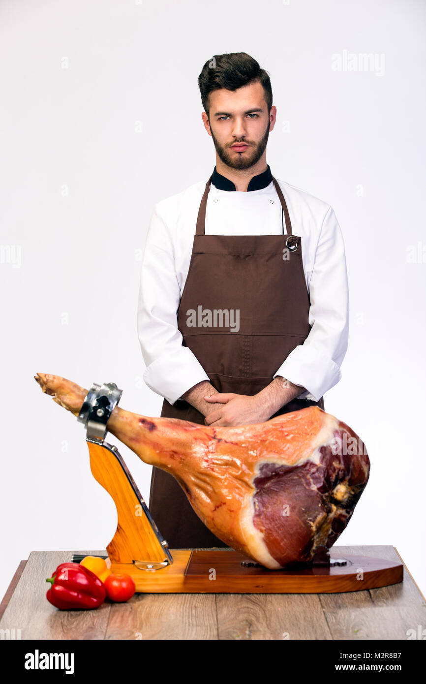 young chef modeling appearance advertises jamon on a white background ...