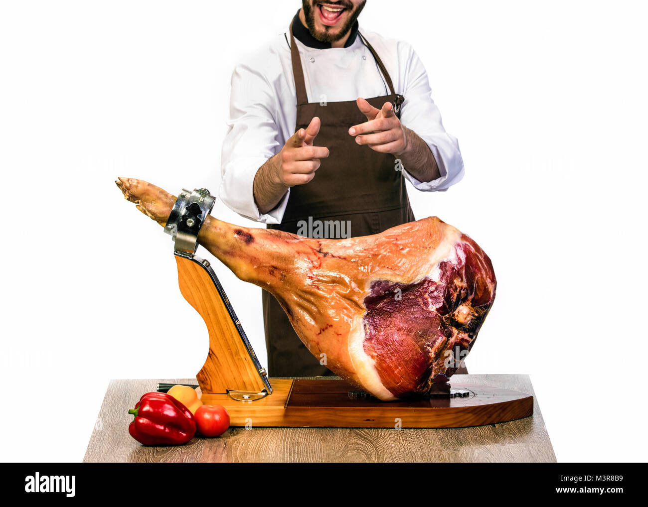 chef smiling pointing fingers at the camera, standing near the table on ...