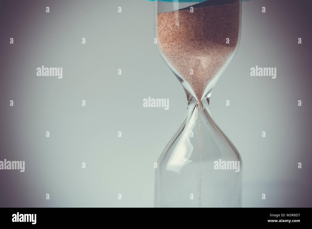 Sand flowing through an hourglass concept for time running out ...