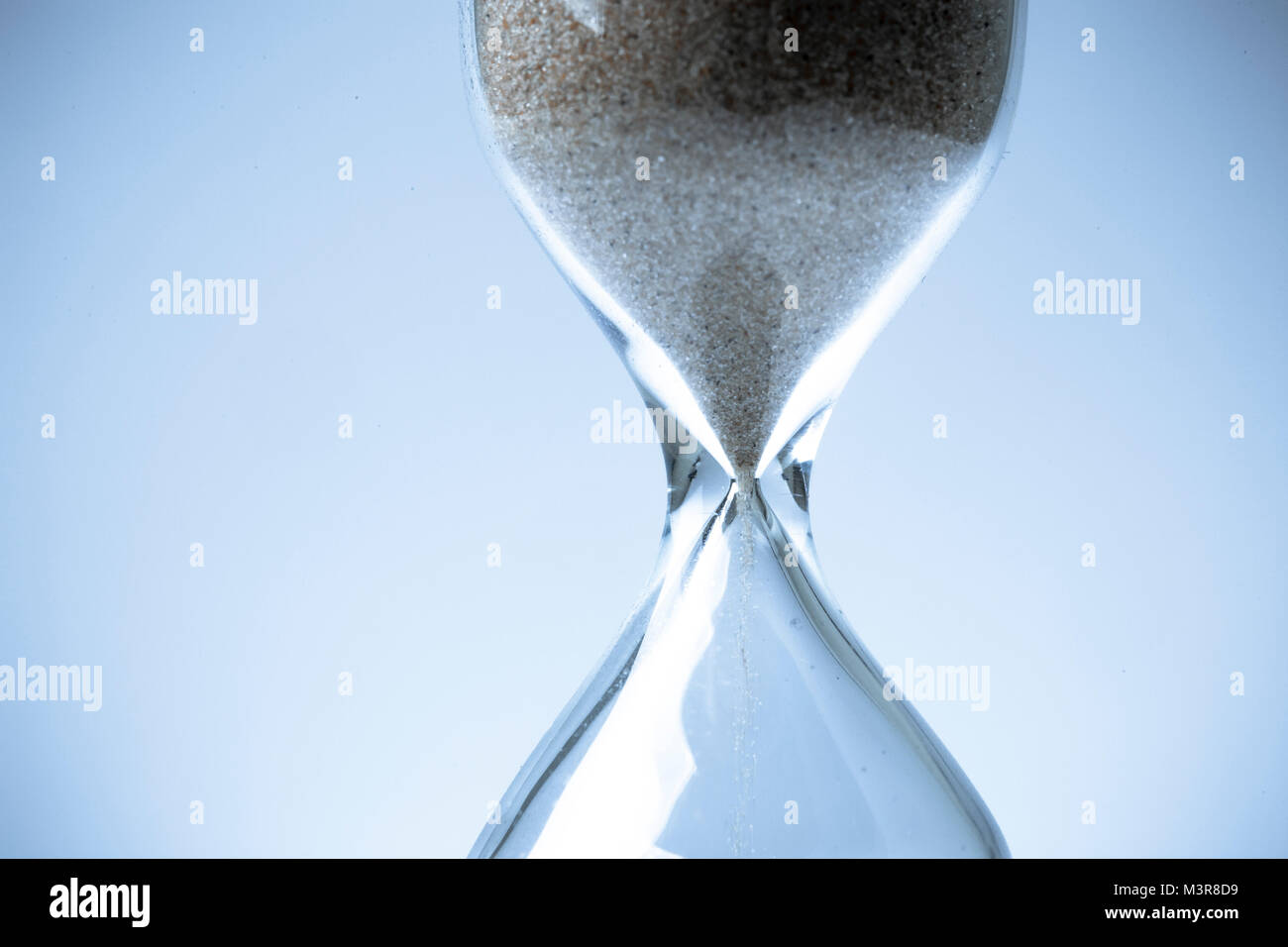 Sand flowing through an hourglass concept for time running out ...