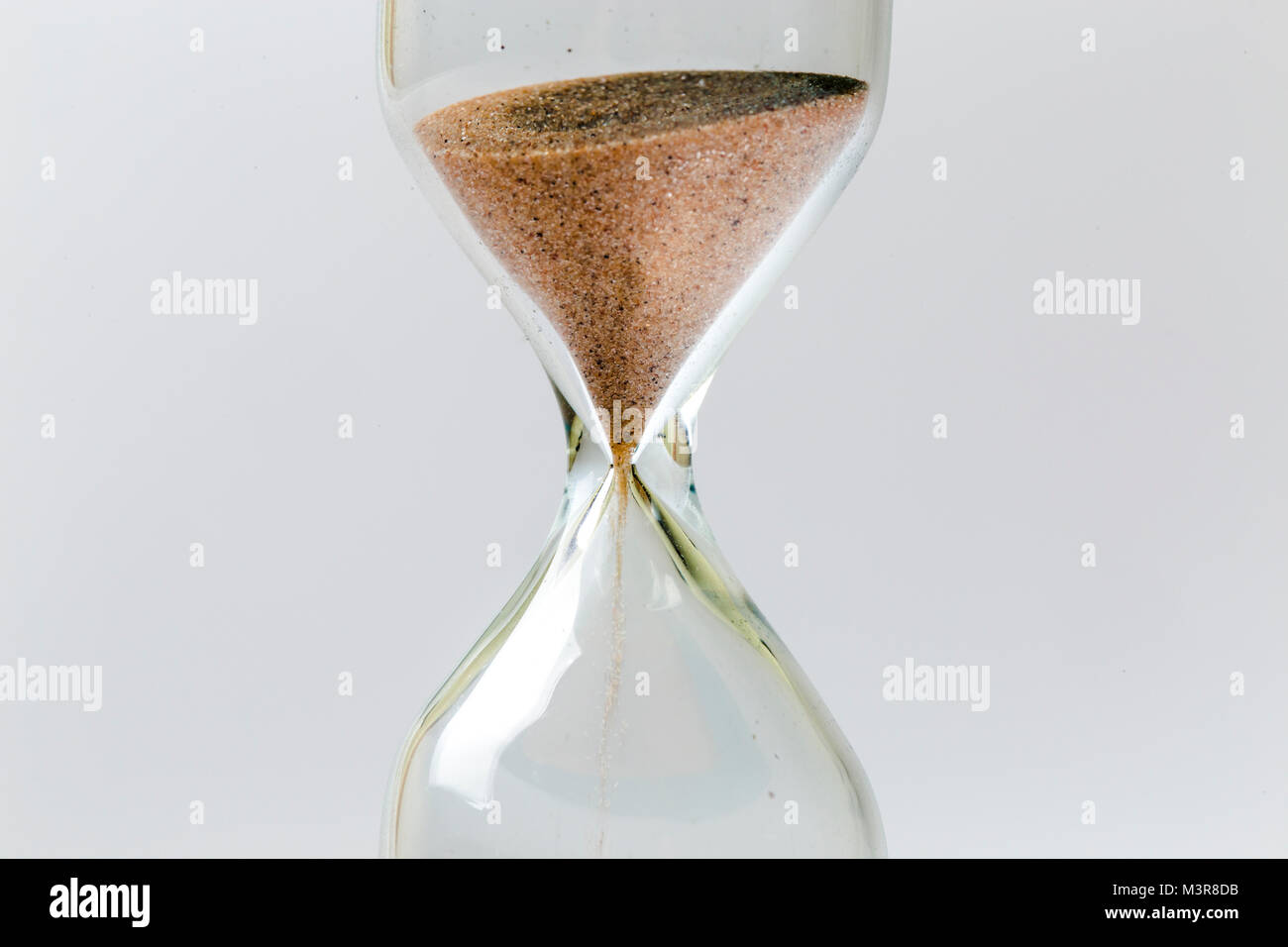 Sand flowing through an hourglass concept for time running out ...