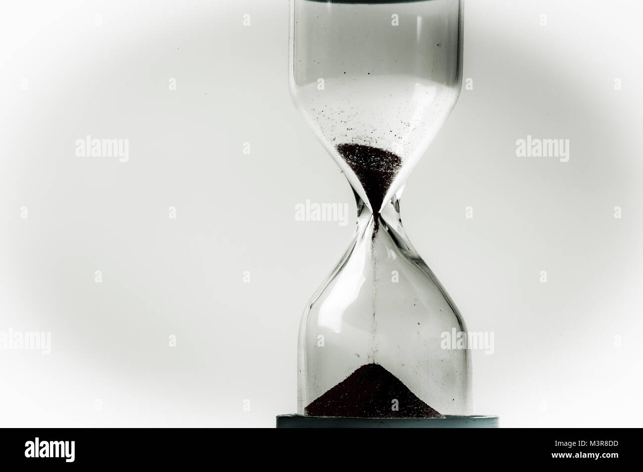 Sand flowing through an hourglass concept for time running out ...