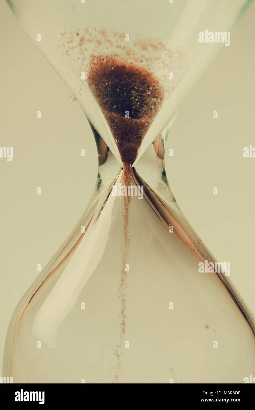 Sand flowing through an hourglass concept for time running out ...