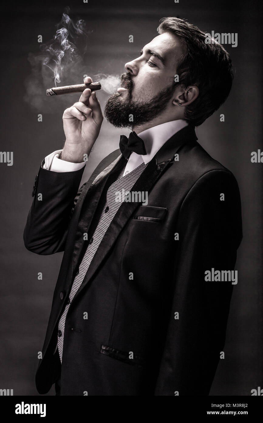 portrait of bearded smoking cigar gentleman in a suit Stock Photo - Alamy
