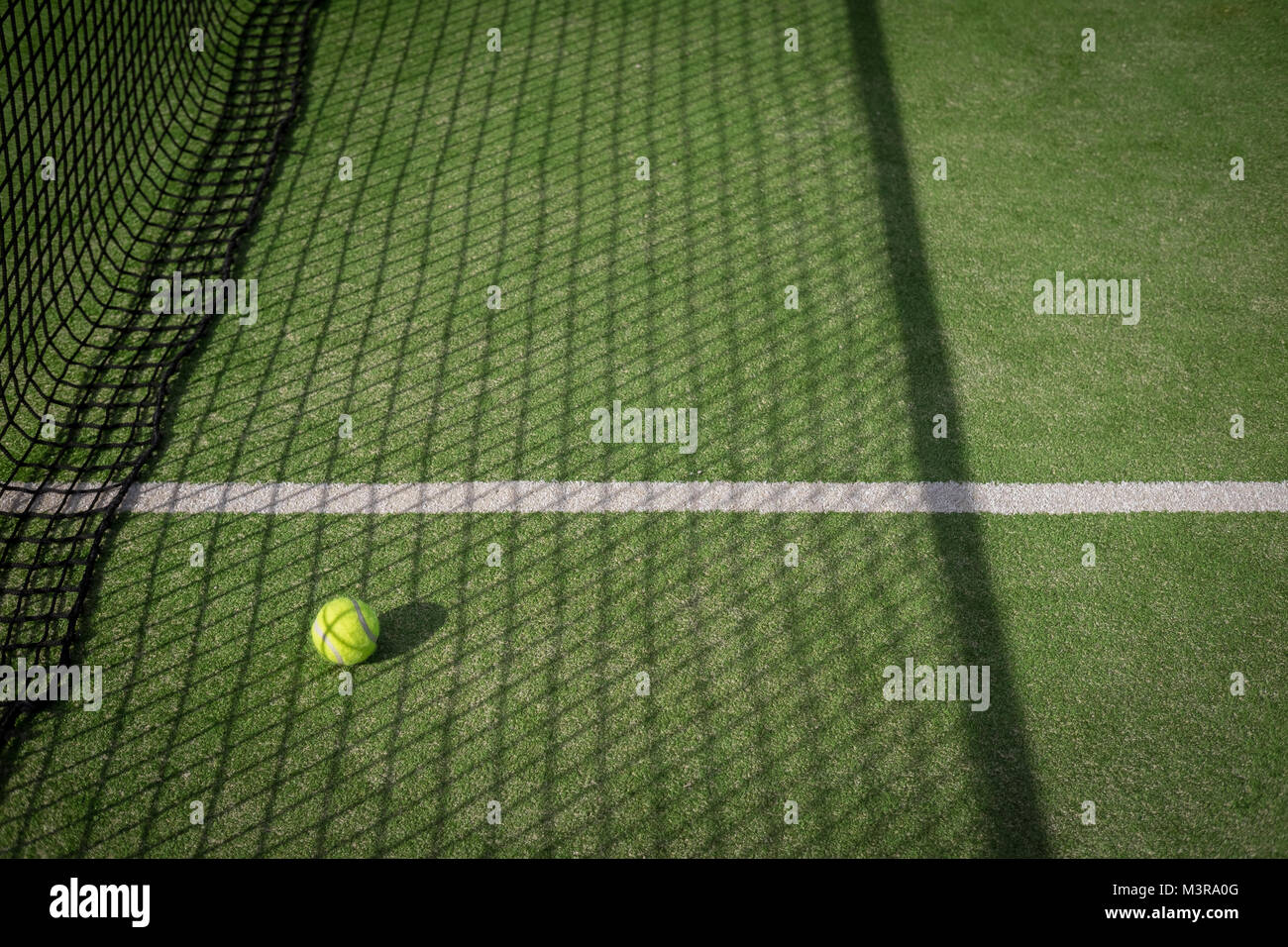 Paddle tennis court and net with a ball Stock Photo - Alamy