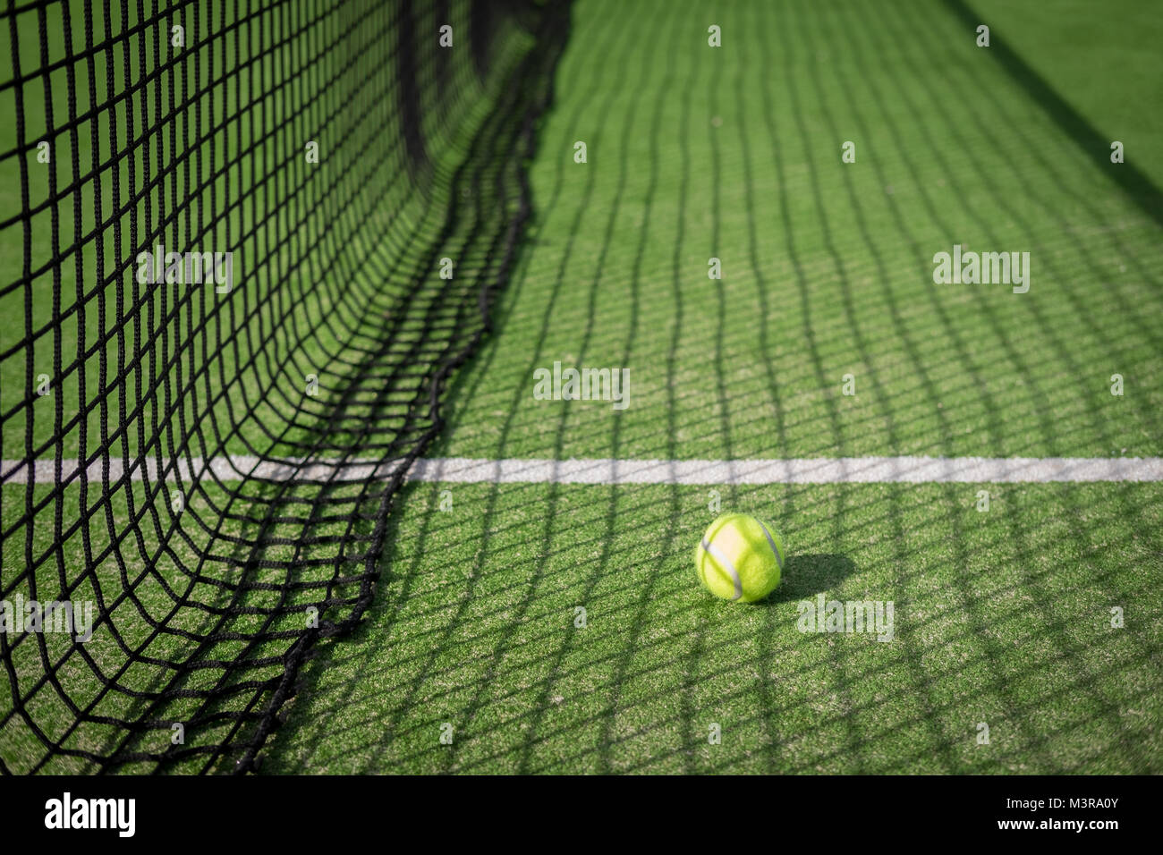 Paddle tennis court and net with a ball Stock Photo - Alamy