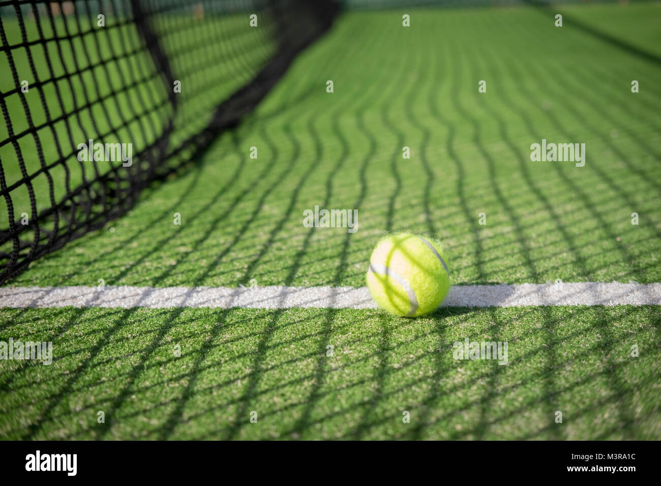 Paddle tennis court and net with a ball Stock Photo - Alamy