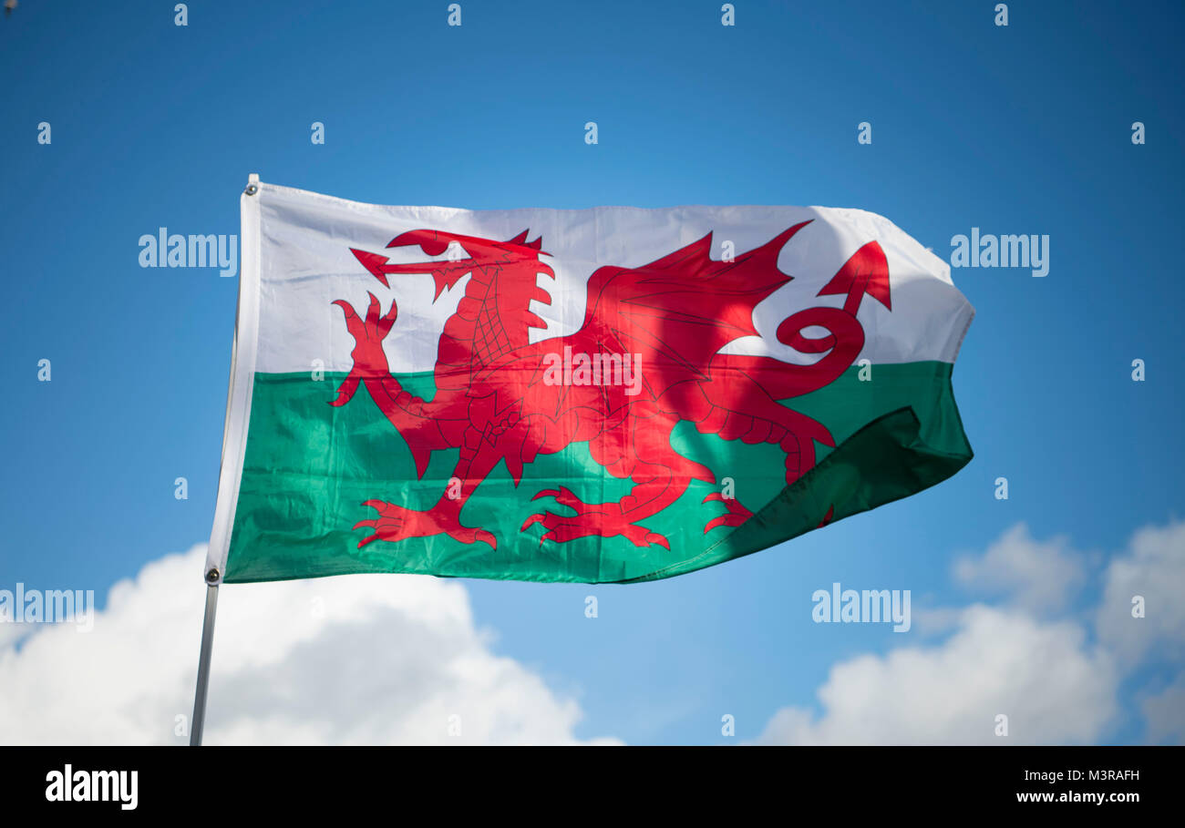 A Wales flag flies against a blue sky on a sunny day in Cardiff, South ...