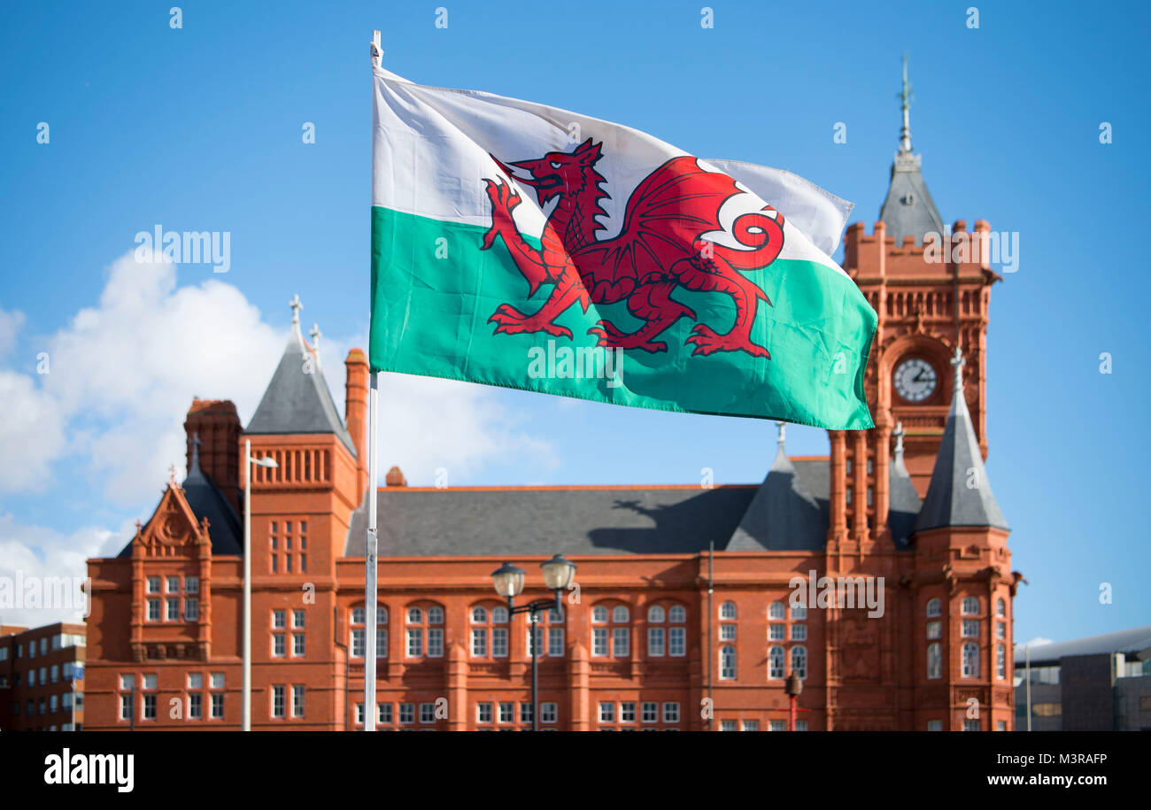 A Wales flag flies against a blue sky in front of the Pierhead Building ...