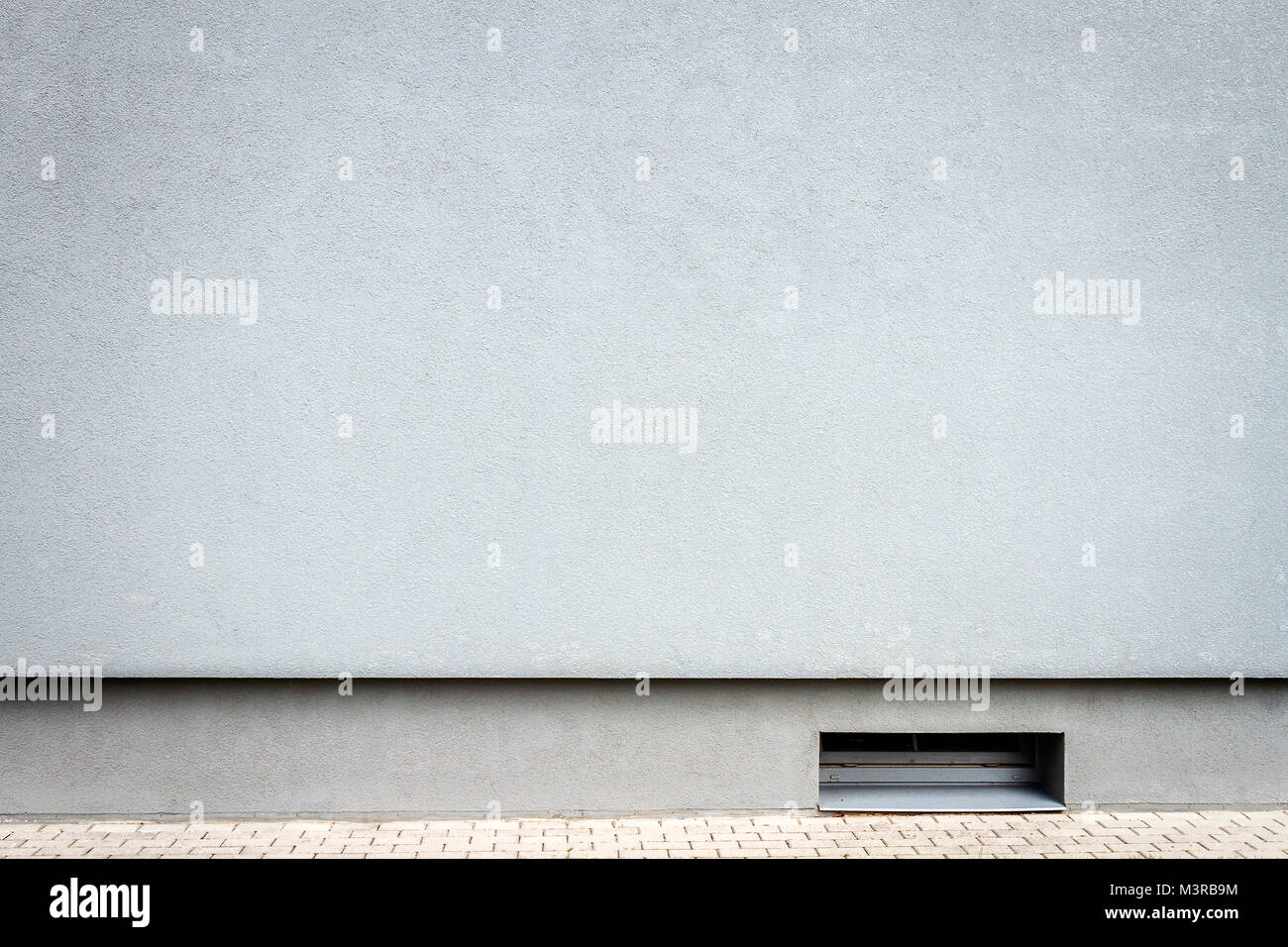 Modern light blue plaster wall with small basement window Stock Photo ...
