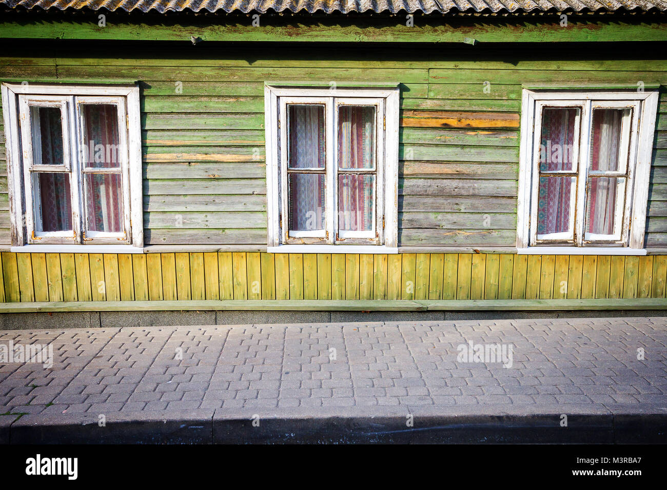 Old green wooden plank wall with some windows Stock Photo - Alamy