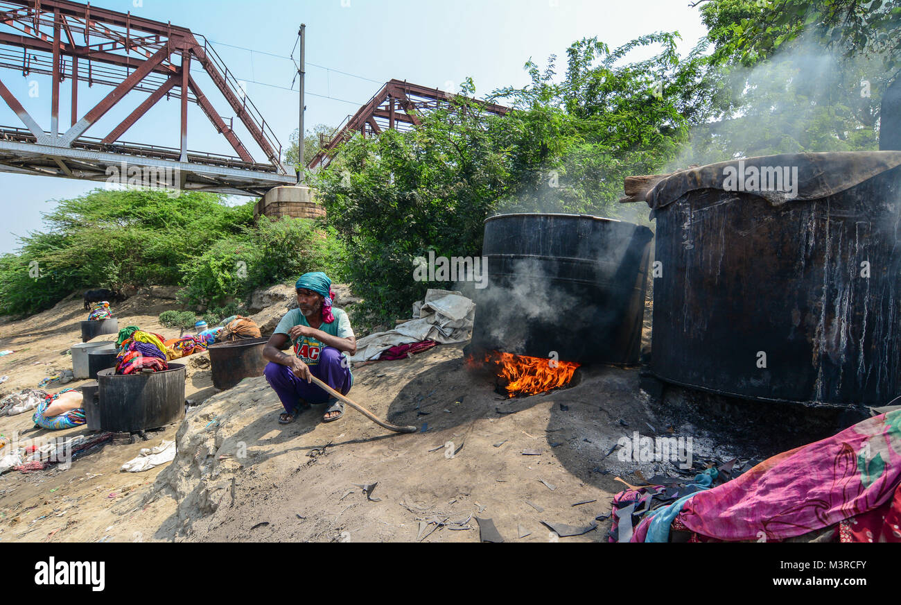 Agra, India - Jul 13, 2015. People dye traditional clothes on Yamuna ...