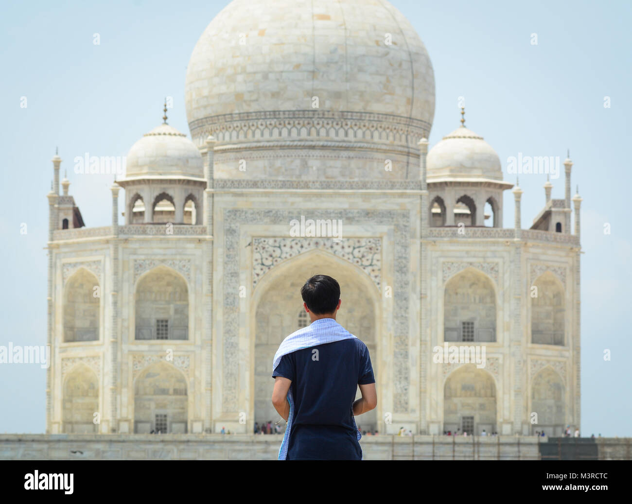 A young man standing and looking at Taj Mahal in Agra, India Stock ...