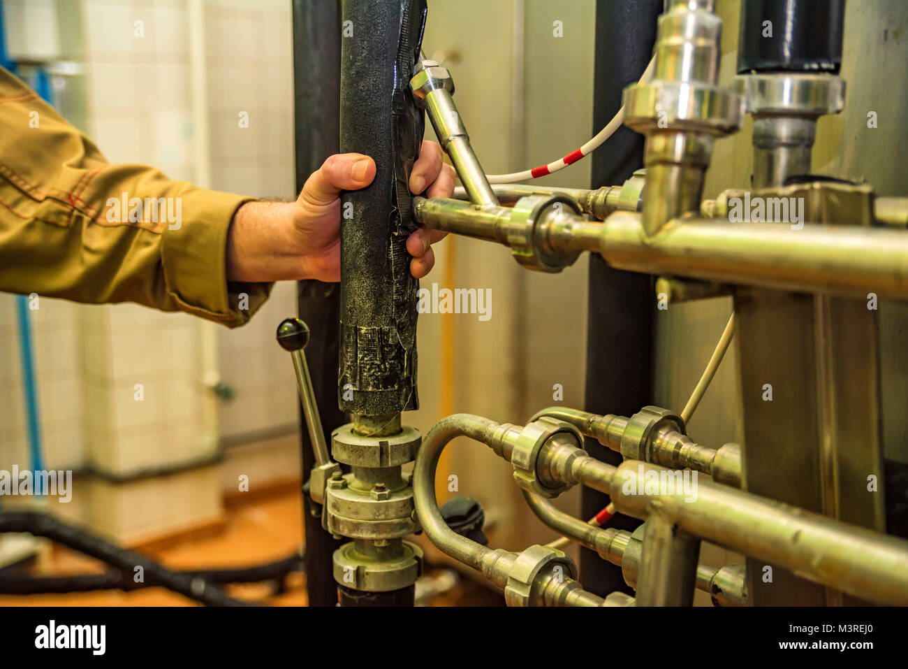 Male hand touches pipes to check them Stock Photo - Alamy