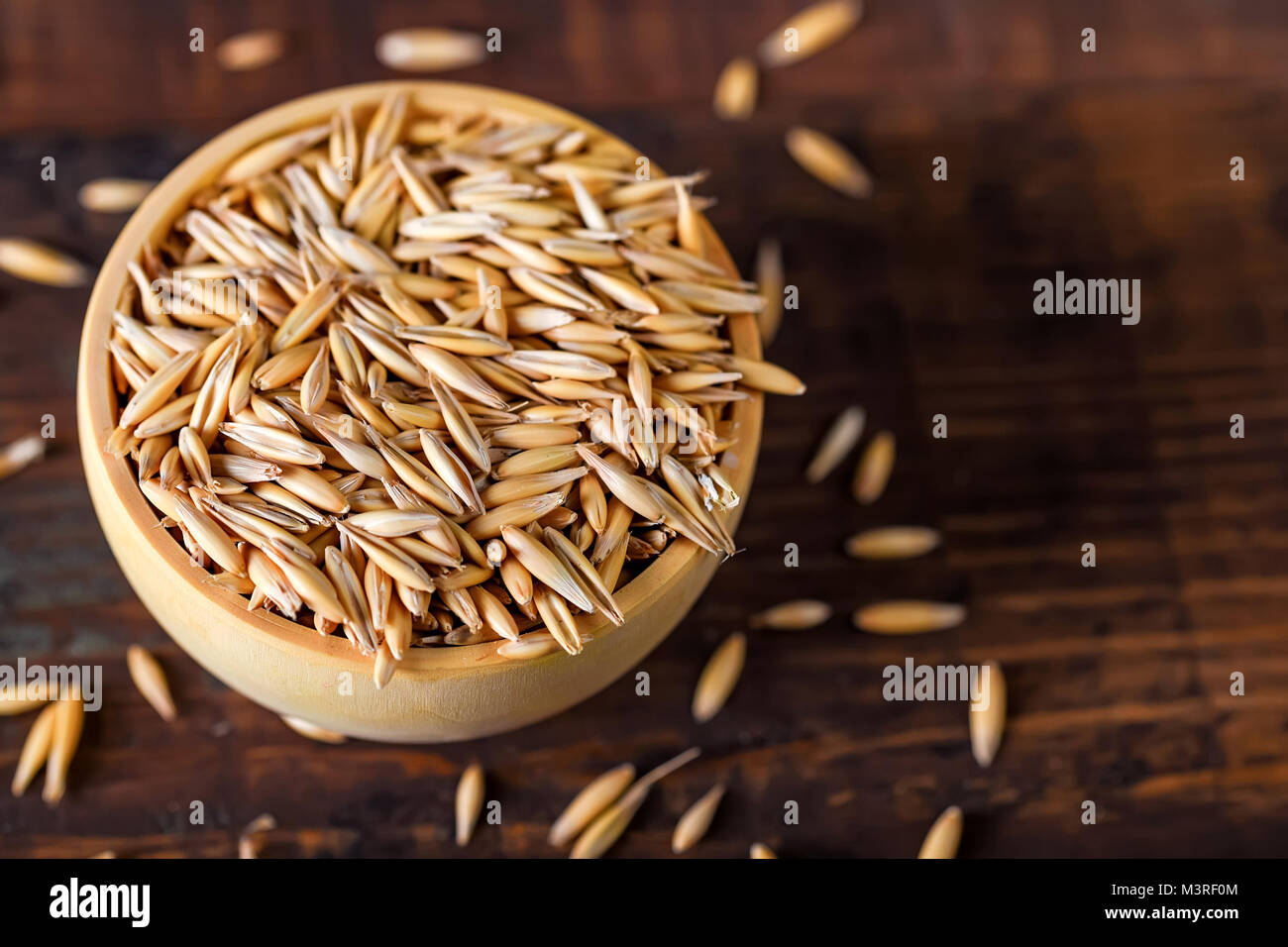 Close up oat grains in wooden bowl Stock Photo - Alamy