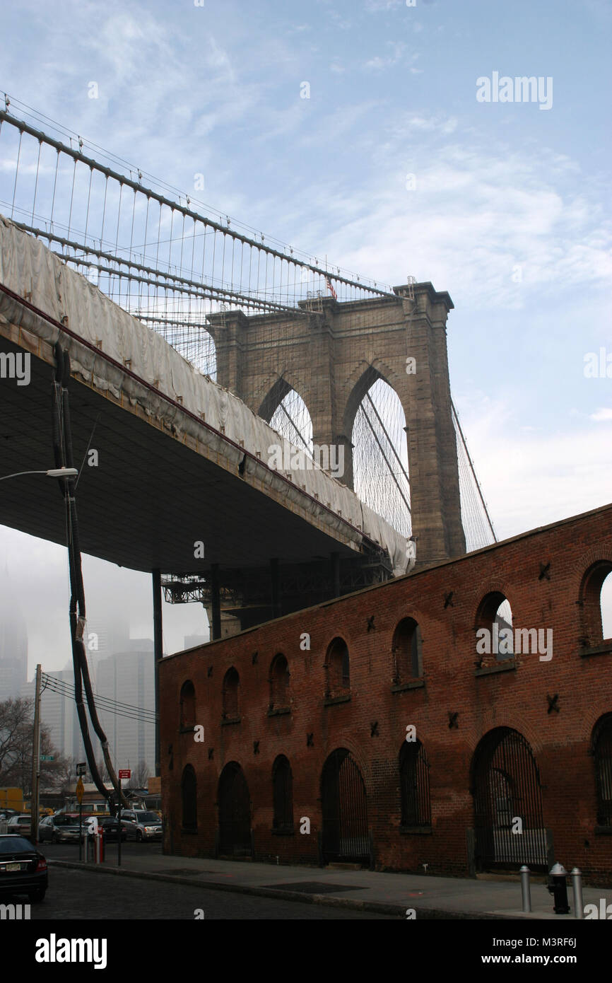 Brooklyn Bridge Tower Over a Building. New York, USA Stock Photo - Alamy