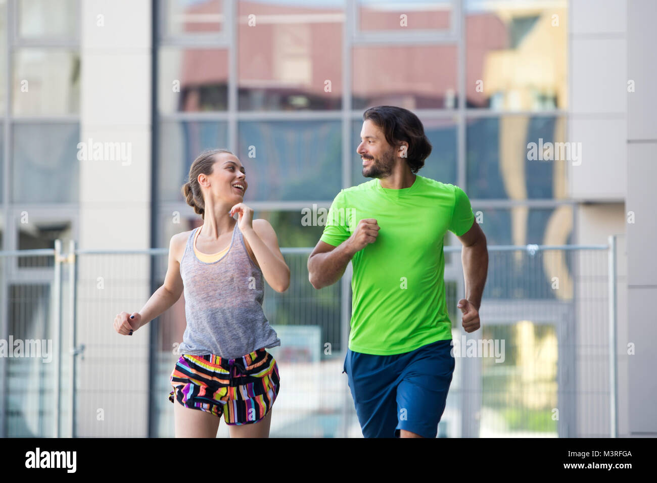 Couple running in urban enviroment at hot summer day Stock Photo - Alamy