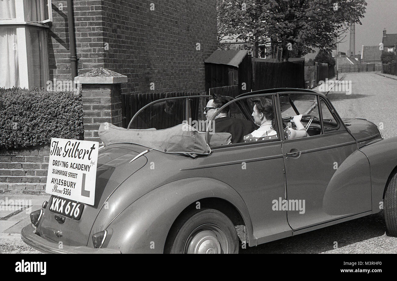 1955, historical, young lady reversing around a corner in an open-top ...
