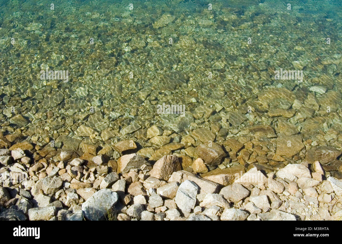 Polish Tatry Tatra, looking into the crystal clear calm water on rocky ...