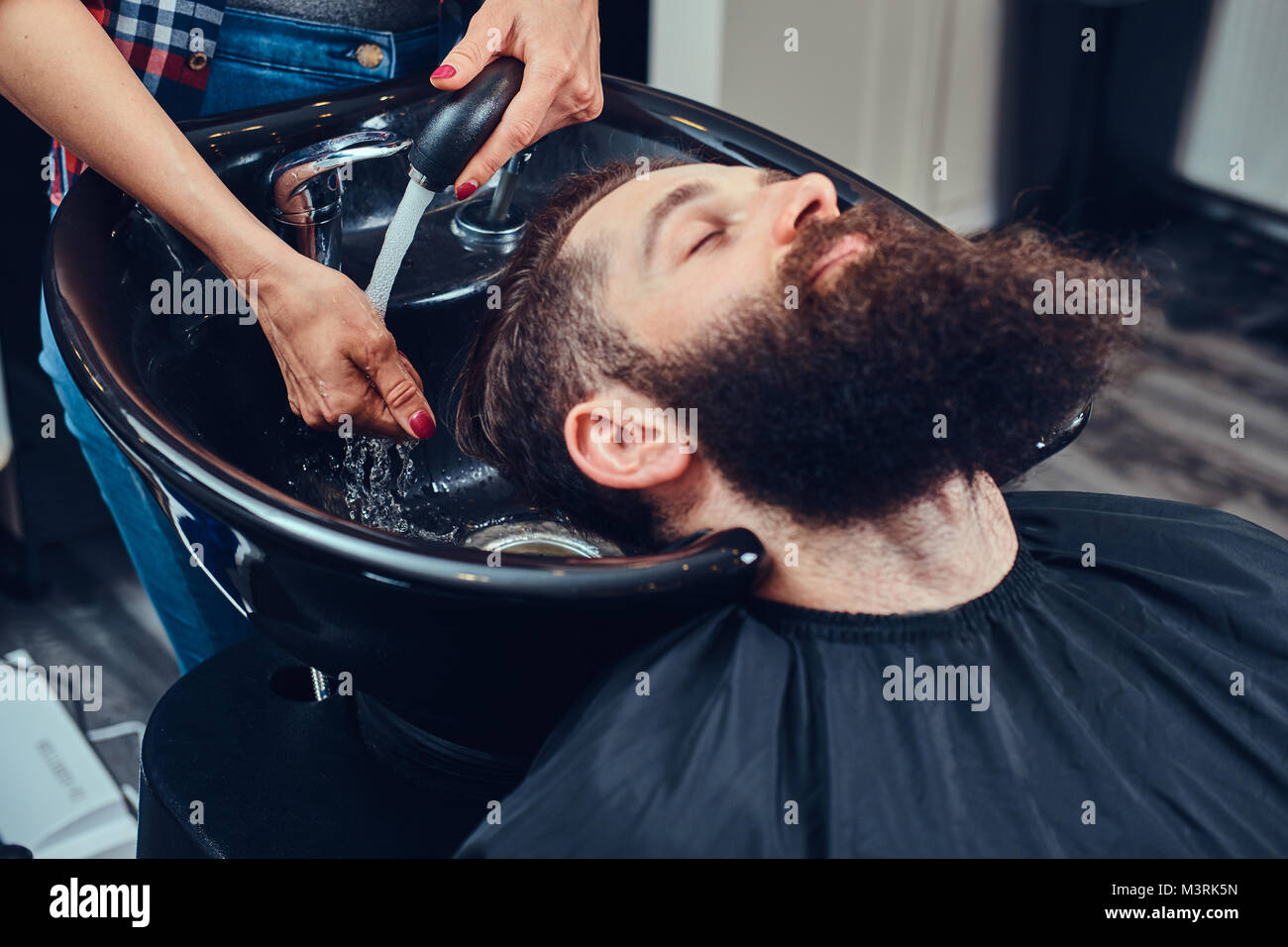 Handsome bearded man in the barbershop Stock Photo - Alamy