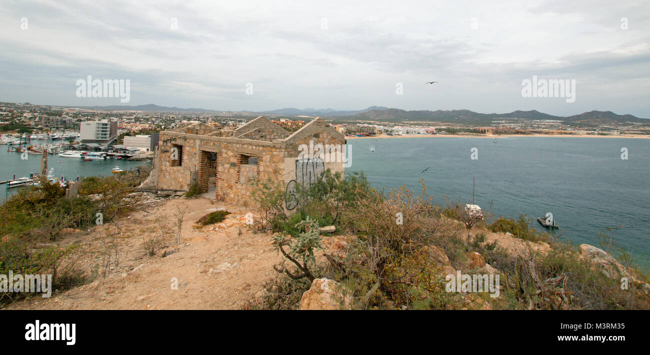Abandoned brick and stone building on hill above Cabo San Lucas marina ...