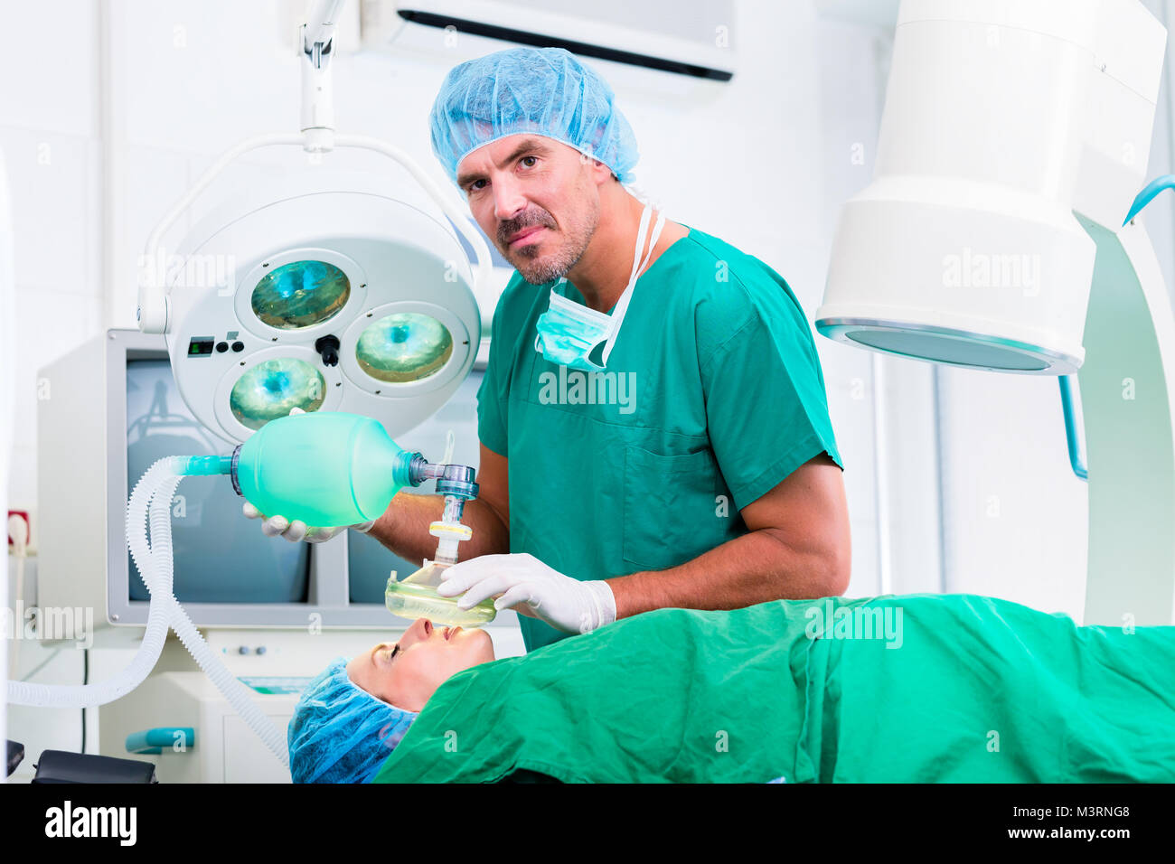 Doctor surgeon with patient in operating room Stock Photo - Alamy