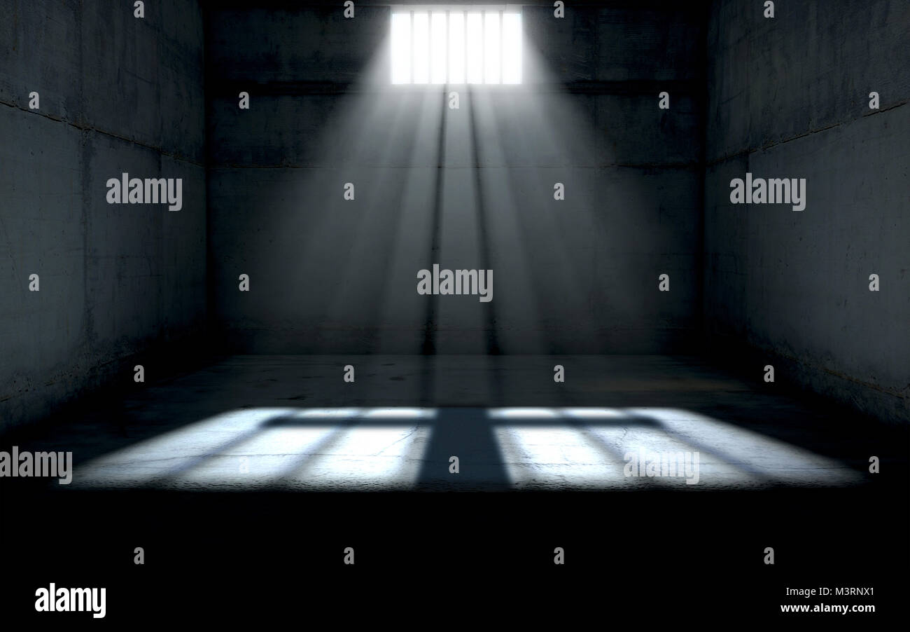 A jail cell interior with a barred up window and light rays penetrating through it casting an ...