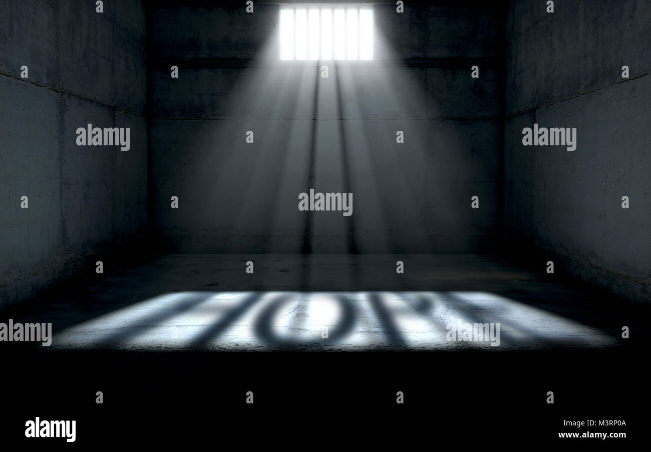 A jail cell interior with a barred up window and light rays penetrating ...