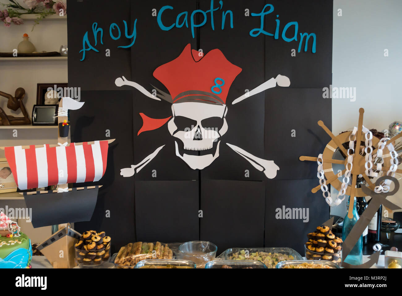 A table set out with food for a child's birthday party with a black ...