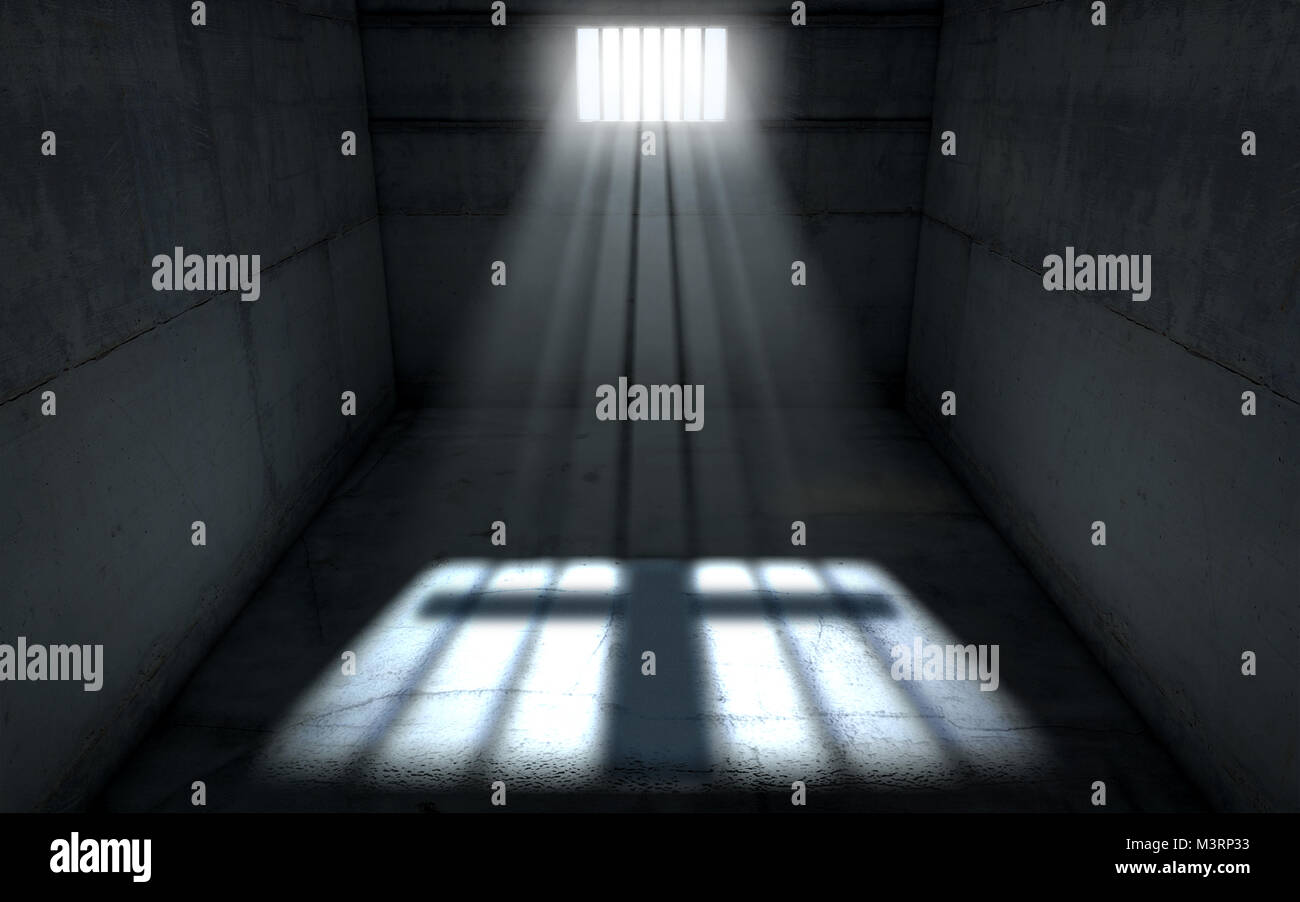 A jail cell interior with a barred up window and light rays penetrating ...