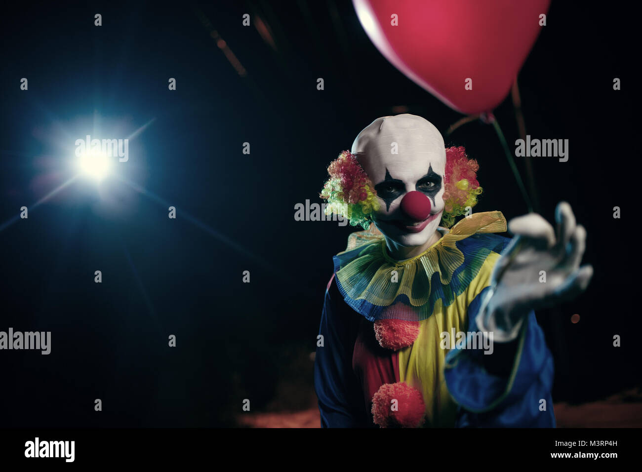 Image of clown with red balloon on background of burning lantern Stock ...