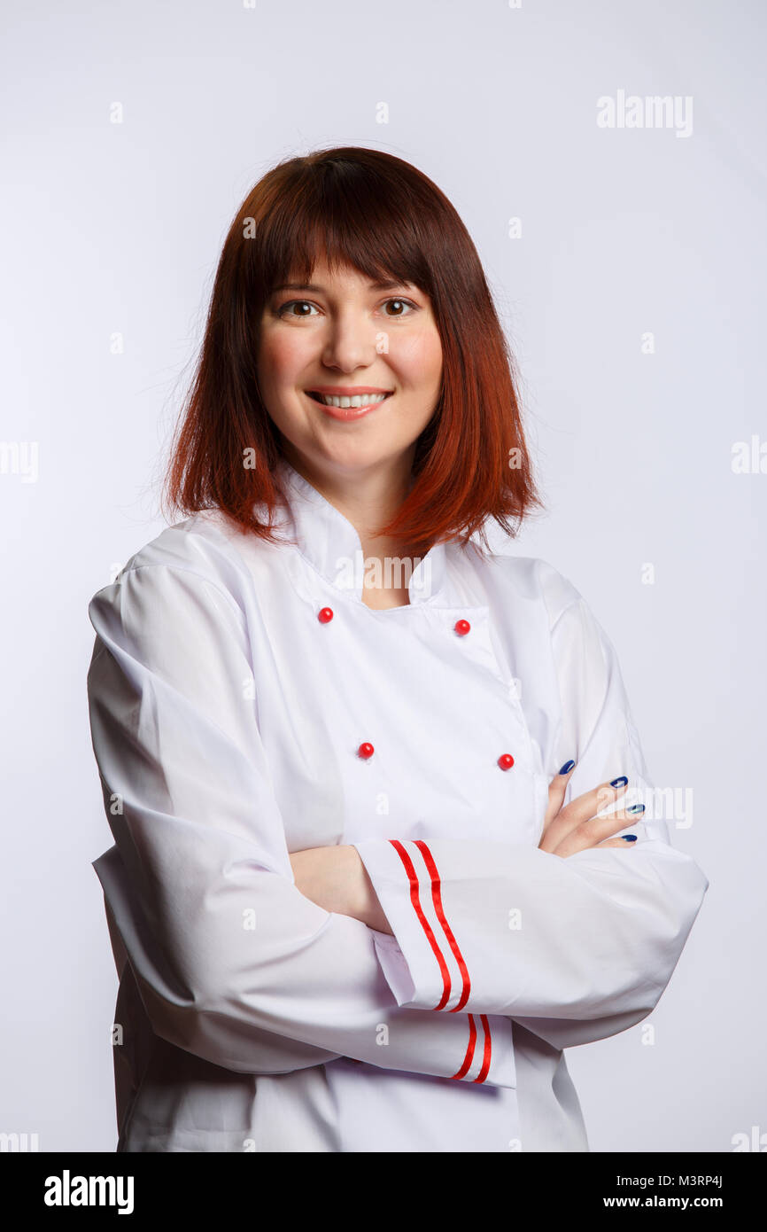 Photo of female chef in white robe on empty background Stock Photo - Alamy