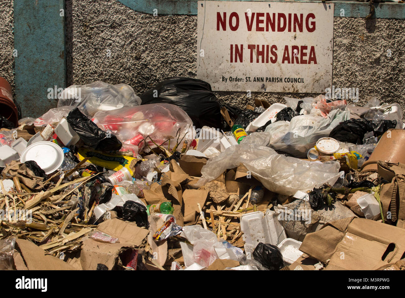 Garbage and sign at the side of Ocho Rios market awaiting collection ...