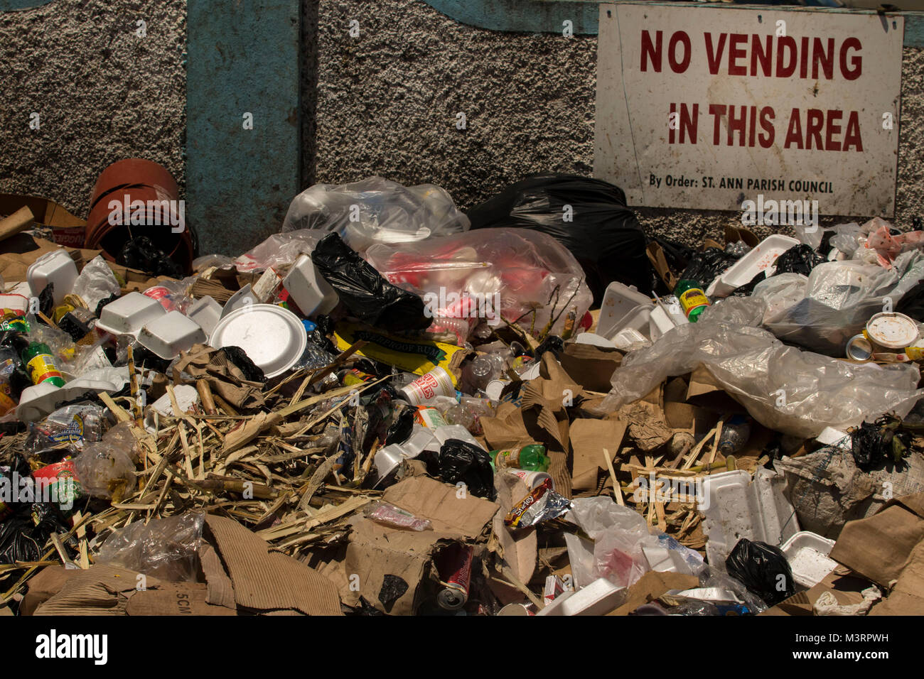 Garbage and sign at the side of Ocho Rios market awaiting collection ...